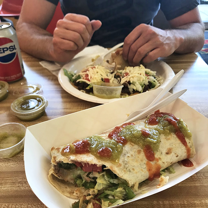 This burrito, adorned with red and green salsas, has more Christmas spirit than most December decorations. A present wrapped in flour tortilla.