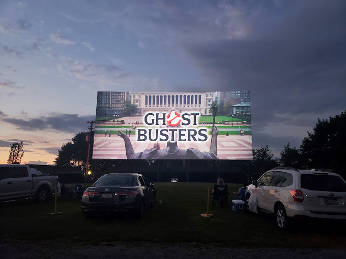 Vintage American automobiles frame the perfect view of that iconic white screen, a scene that could be from 1955 or yesterday. 