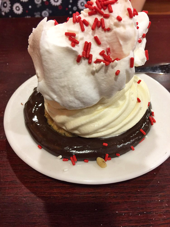 This isn't just dessert&mdash;it's architecture. Ice cream and whipped cream create a towering monument to indulgence, complete with festive sprinkle confetti.