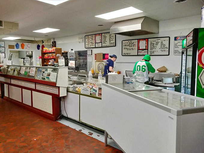 Where the magic happens – behind the counter, dedicated staff create the hot dogs and ice cream that have kept locals coming back since 1906.