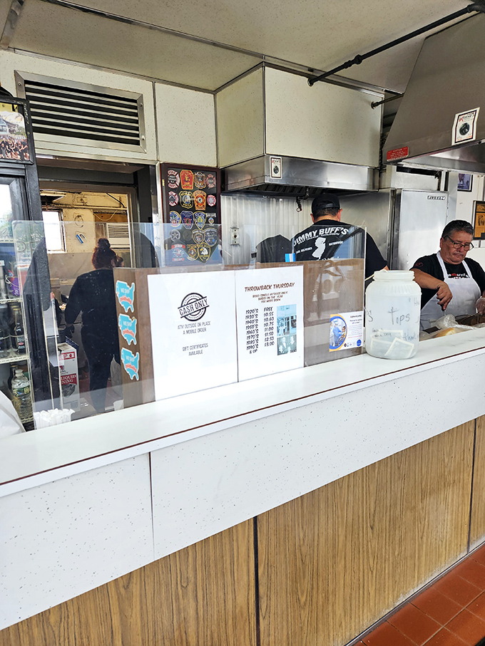 Behind this counter, New Jersey food history is made daily. The plexiglass isn't a barrier&mdash;it's a window to hot dog heaven.
