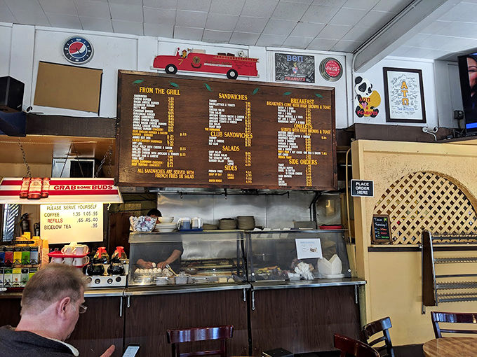 The heart of the operation: a classic counter setup where culinary magic happens. Old-school menu boards remind us that sometimes, tradition tastes best.