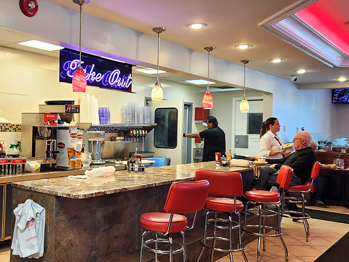 The counter where solo diners become part of the City Cafe family. Those red stools have heard more stories than most bartenders.