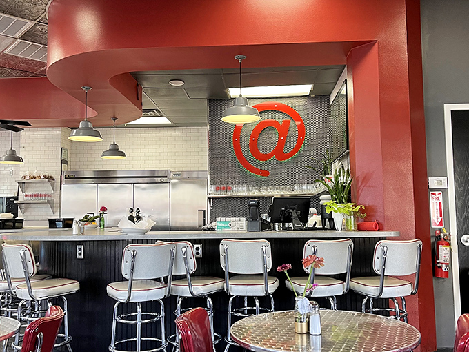 Counter seating: where you can watch breakfast magic happen in real time. That red @ sign watches over the proceedings like a culinary guardian angel.