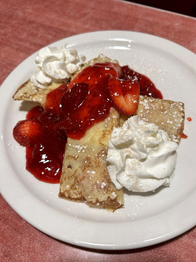 Delicate crepes dressed with strawberries and whipped cream &ndash; because sometimes breakfast should feel like you've accidentally wandered into a Parisian caf&eacute;.