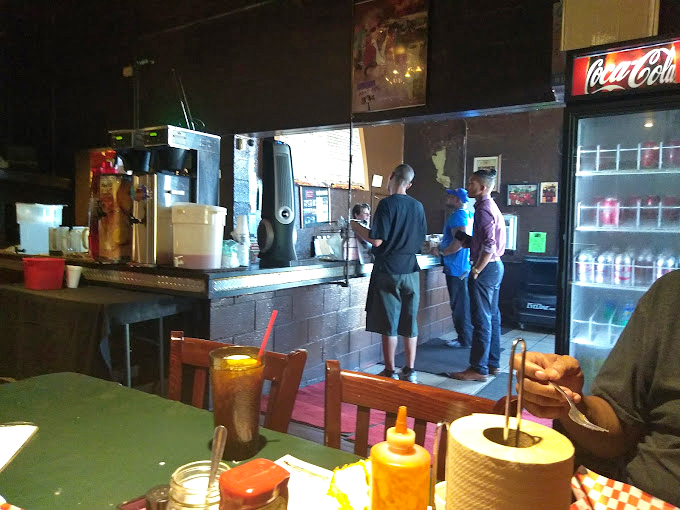 Regulars know the drill: order at the counter, grab a drink from the cooler, then prepare for a barbecue experience worth writing home about.