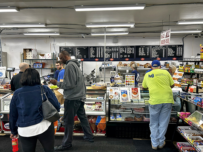 The lunch rush at Malin's &ndash; where hungry customers gather at the counter like pilgrims who've found their sandwich sanctuary.