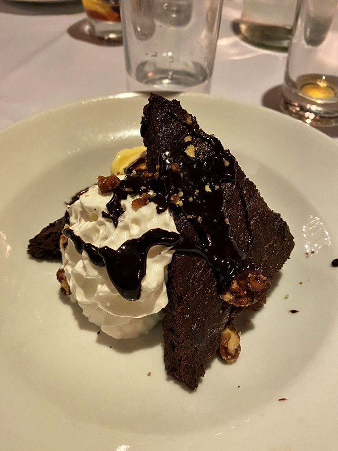 As dusk falls, the illuminated stone exterior and glowing red sign become a siren call for those seeking serious sustenance.