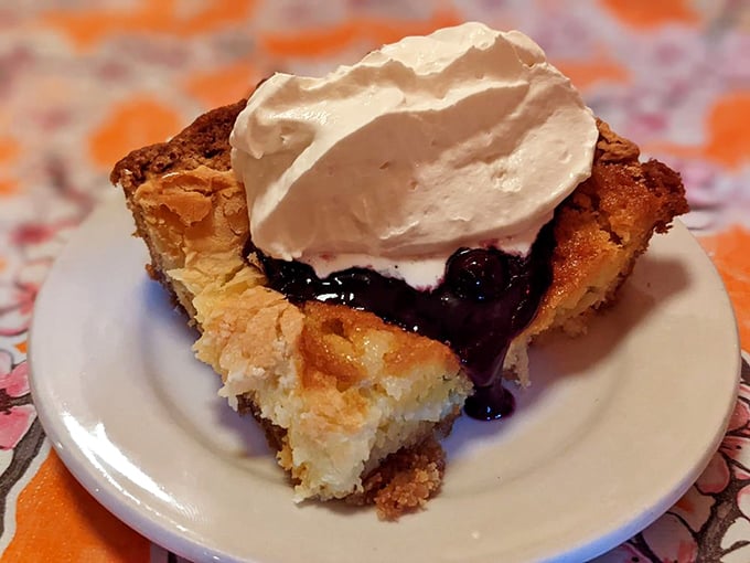 Finish your night with a slice of warm, golden cobbler topped with sweet berry sauce and a generous dollop of cream.