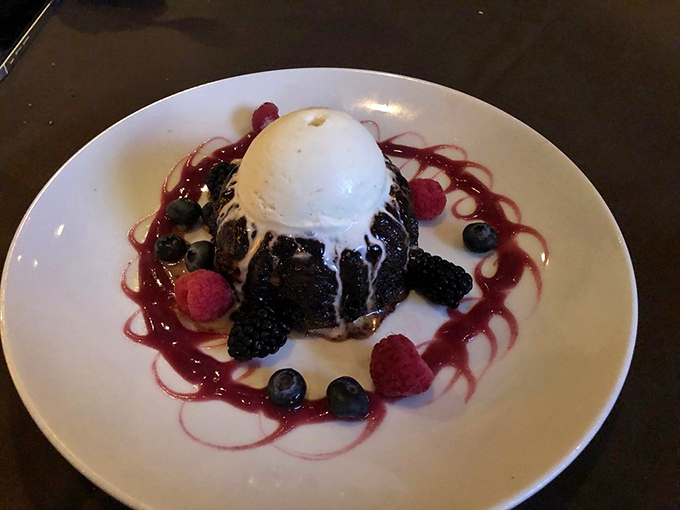 A chocolate dessert that doesn't know the meaning of restraint, crowned with ice cream and surrounded by berries &ndash; because endings matter.
