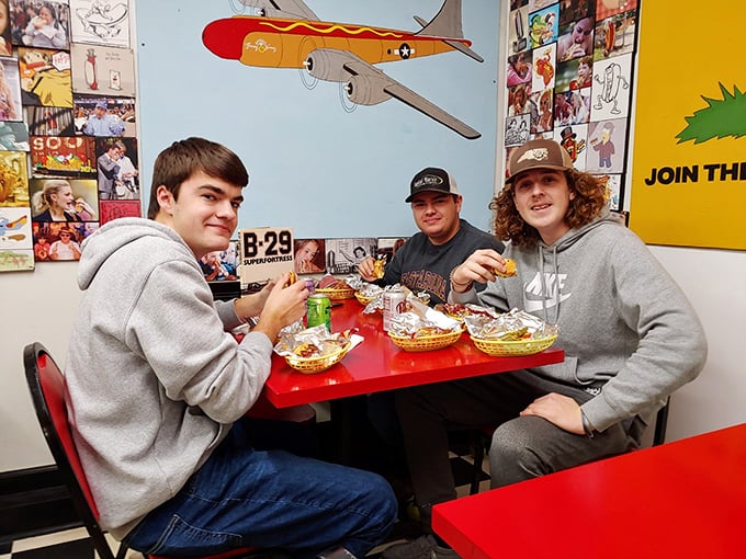 Where friendships are strengthened over shared hot dog experiences. The airplane overhead seems to be surveilling their delicious decisions.