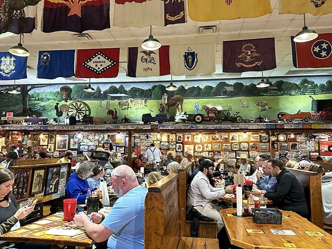 Under a canopy of state flags, strangers become dining companions, united by the shared experience of watching bread fly across the room with delightful abandon.