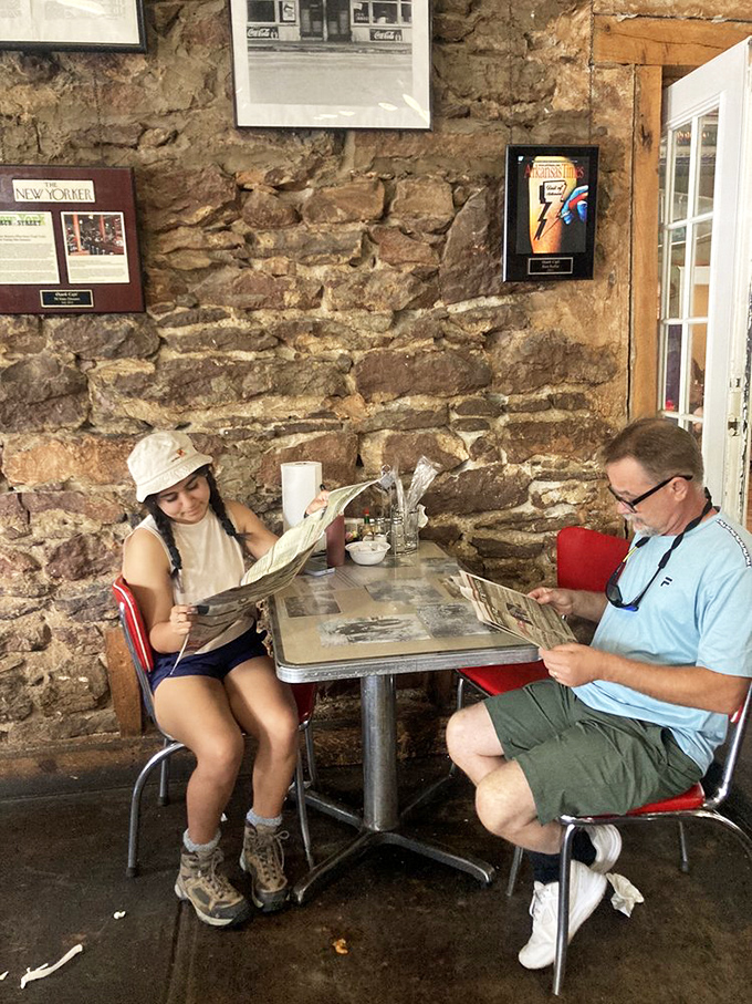 Even the stone walls tell stories at Ozark Cafe, where diners pause between bites to read the newspaper—some traditions technology can't improve upon.