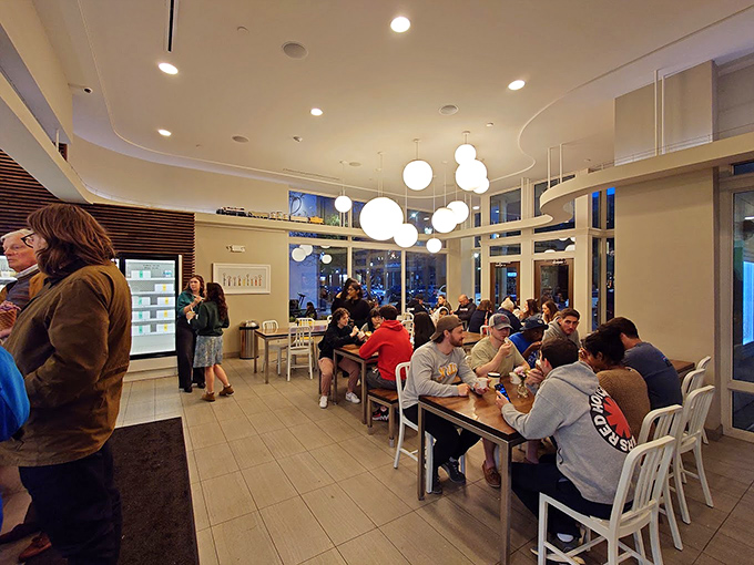 The modern ice cream parlor: where strangers become comrades united by the universal language of "mmm." Democracy in action, one scoop at a time.