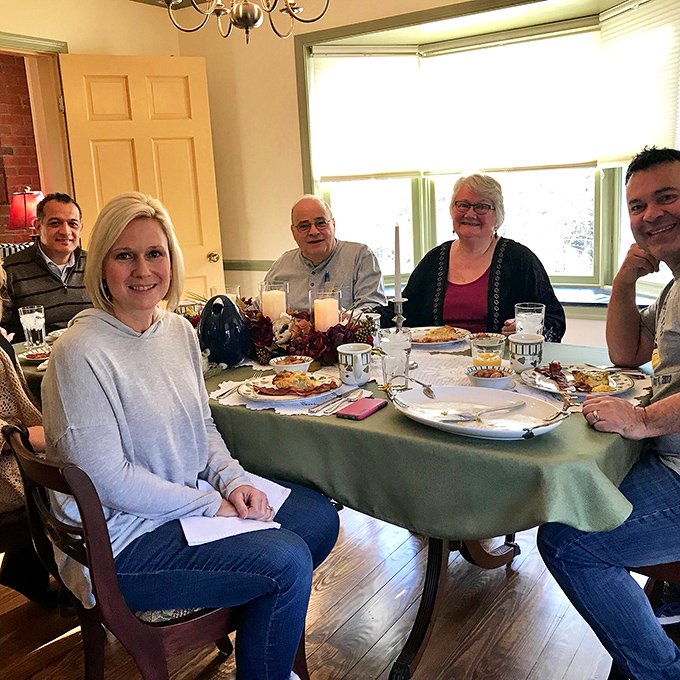 The breakfast table where strangers become friends over coffee and shared recommendations about which historic homes to visit after your second helping.