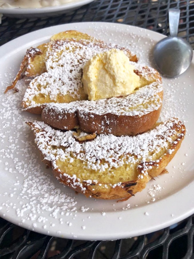 French toast that renders the phrase "I'll just have a bite" completely meaningless. That powdered sugar snowfall seals the breakfast deal.