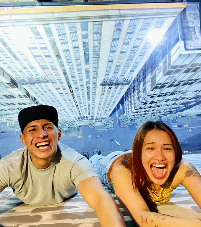 The museum's optical illusion floor creates the perfect Instagram moment as visitors appear to dangle precariously above city streets.