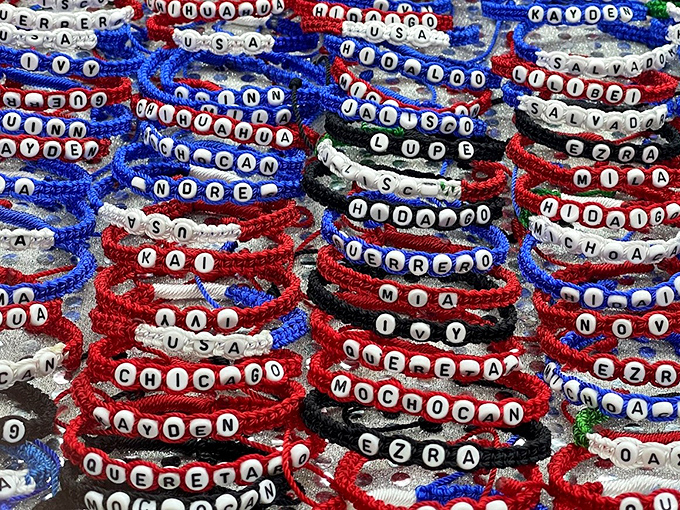 Names and places woven into wearable mementos, where Chicago, Michigan, and personal identities intertwine in rainbow-hued friendship bands.