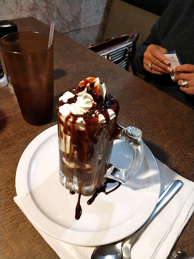 This hot fudge sundae isn't just dessert—it's therapy in a glass mug, topped with the kind of chocolate drizzle dreams are made of.