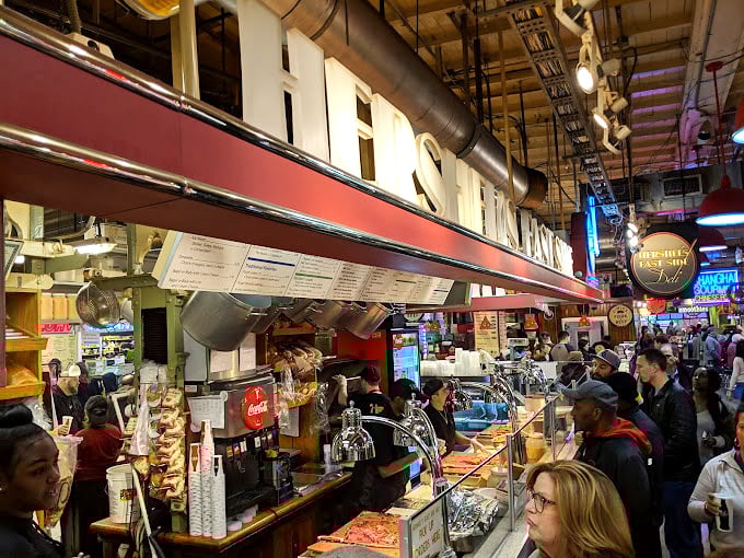 The line forms not out of obligation but anticipation. These aren't just customers&mdash;they're pilgrims on a quest for the perfect pastrami.
