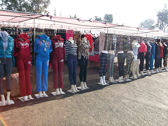 The silent sentinels of style stand at attention, modeling affordable fashion with perfect posture and zero complaints about the heat.