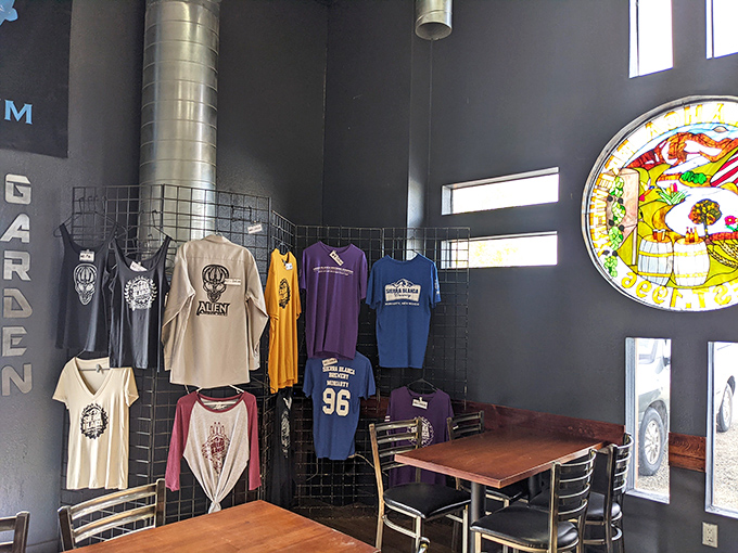 Beer fashion statement! Sierra Blanca's merch corner lets you wear your beverage allegiance proudly, with the stained glass adding artistic flair.