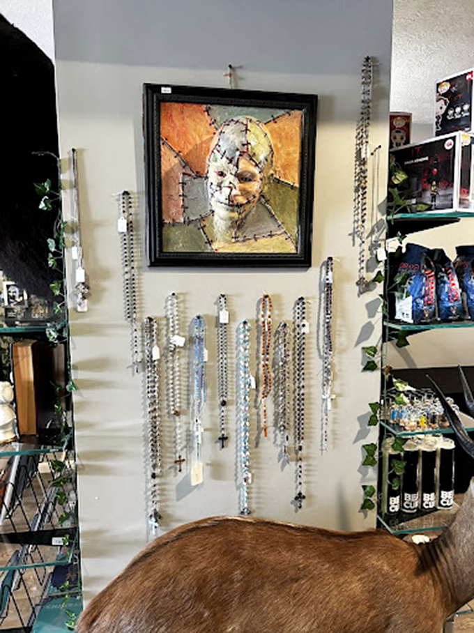 Rosaries and religious jewelry hang beneath unsettling artwork, exemplifying how Beardo's juxtaposes the sacred and profane throughout its curious collections.