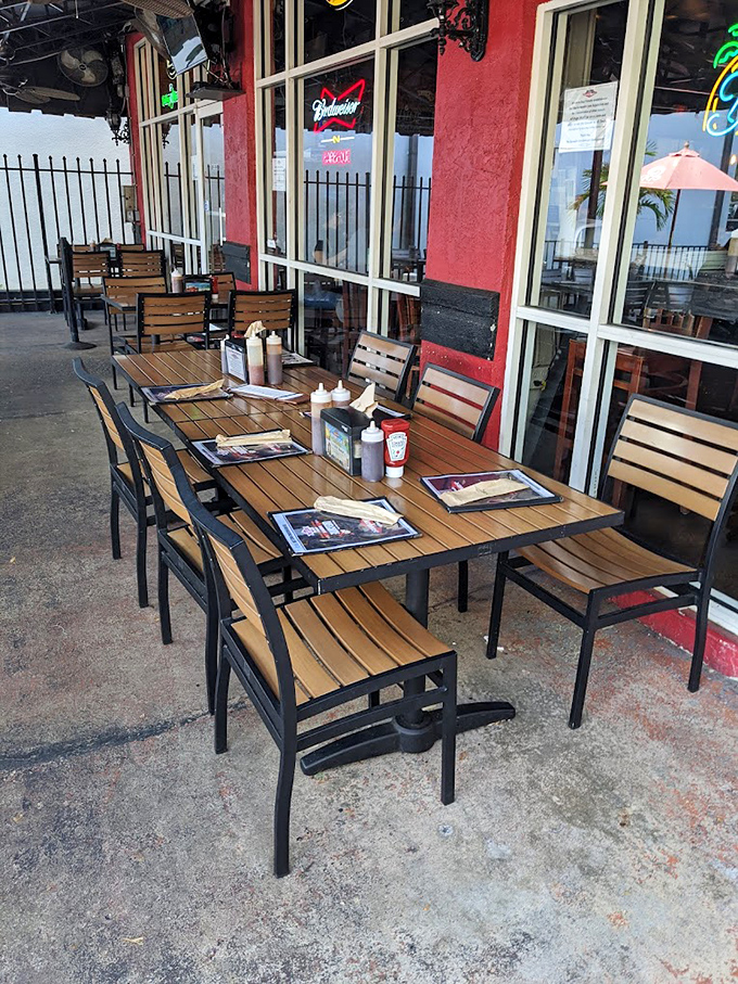 Outdoor dining at its finest&mdash;sauce bottles standing at attention, ready for duty on tables bathed in Florida sunshine.