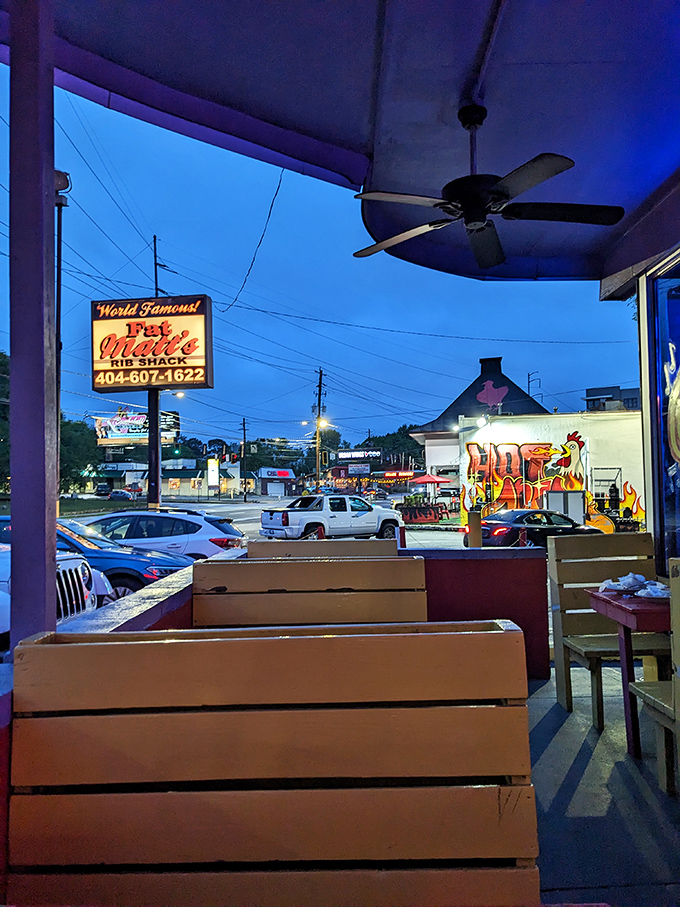 As evening falls, the outdoor seating at Fat Matt's transforms into a front-row seat to Atlanta's barbecue theater.