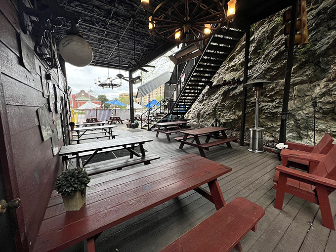 The outdoor patio carved into the hillside offers a rustic retreat &ndash; picnic tables nestled against natural rock walls create the perfect post-meal hangout spot.