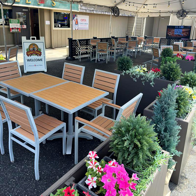 The outdoor dining area, where fresh air and fresh food create the perfect equation for happiness. Even the plants look well-fed.