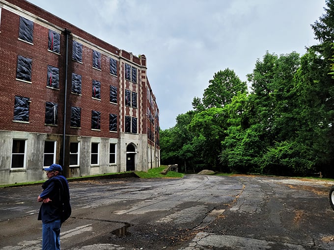 The sprawling complex emerges from the Kentucky forest like a brick behemoth, its windows boarded up but unable to contain its stories. 