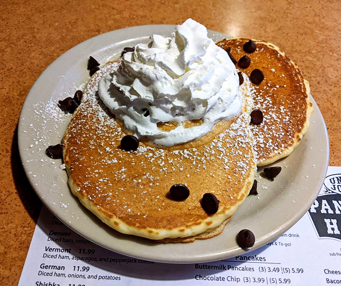 Pancakes topped with a cloud of whipped cream and chocolate chips—the breakfast that makes adults feel like kids and kids feel like they've won the lottery.