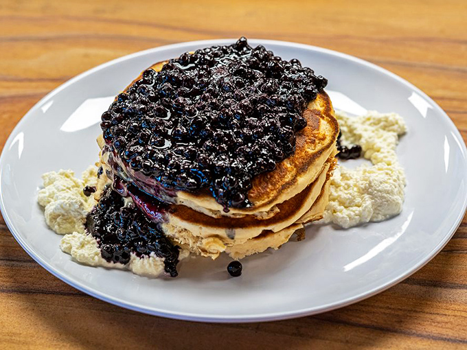 Pancakes stacked high and smothered with blueberry compote and cream&mdash;a tower of breakfast decadence that makes you want to cancel all appointments for the day.