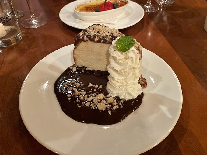 Cheesecake swimming in chocolate sauce&mdash;because after conquering a steak, you deserve a victory dessert. The whipped cream tower stands like a monument to indulgence. 