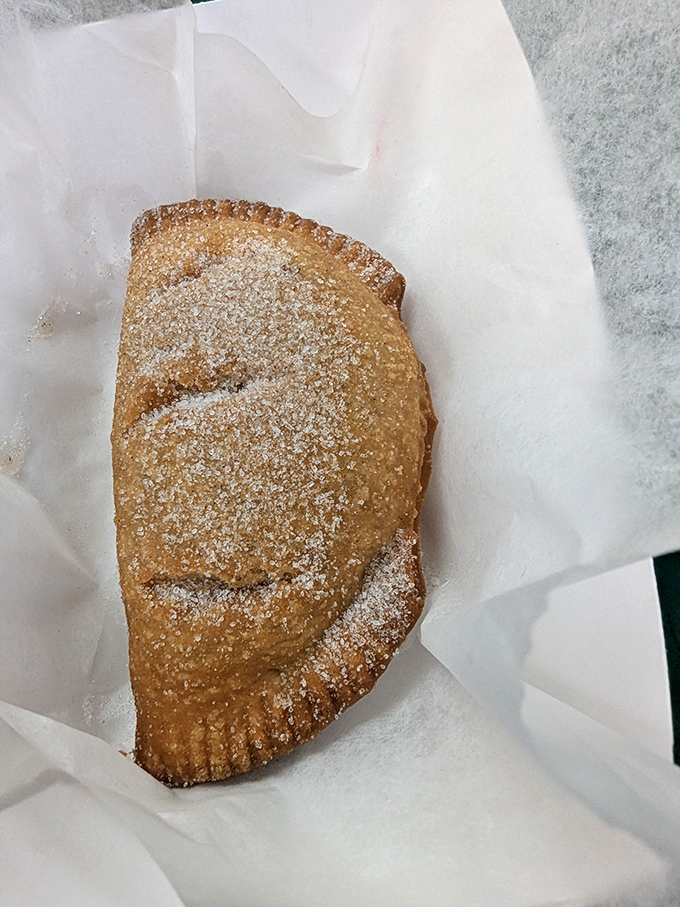 Fried pie dusted with powdered sugar &ndash; dessert's answer to the question "How can I be happier right now?" Sweet, flaky perfection.
