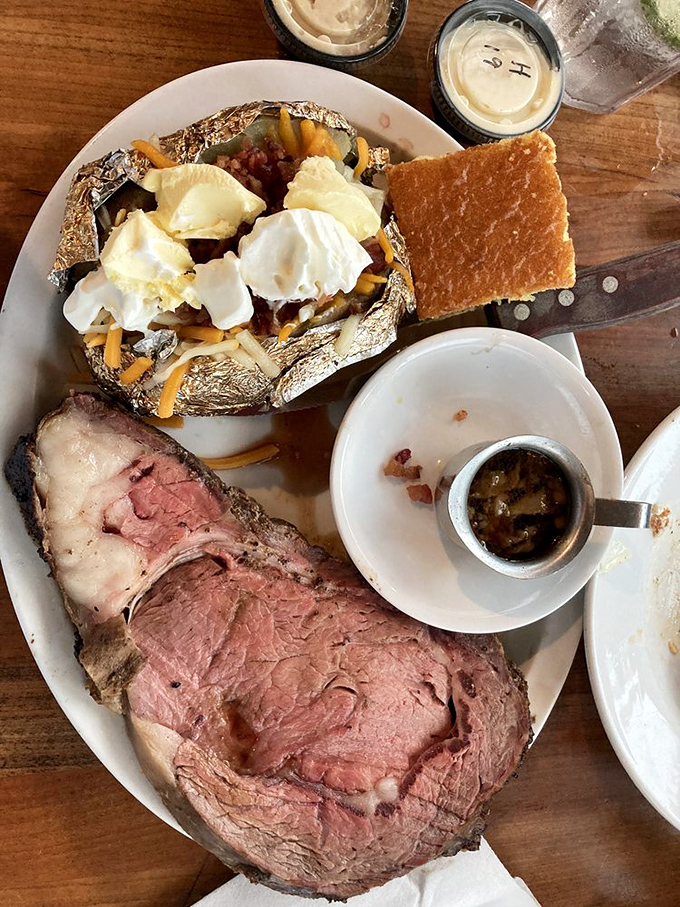 Prime rib cooked to that perfect shade of pink, alongside a loaded potato—proof that sometimes the simple classics are unbeatable for a reason.