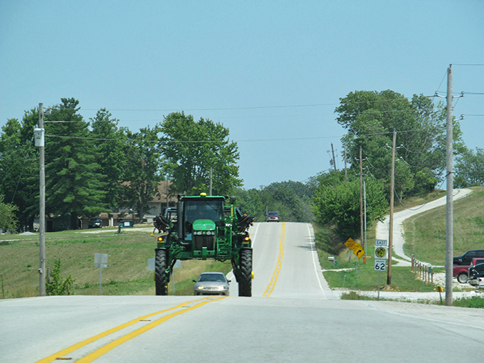 Sometimes the journey is better with company. Even farm equipment shares the road on Highway 62, where modern agriculture meets historic routes.