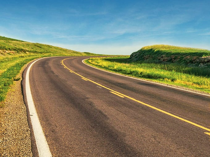 The road curves like a smile through the hills. Even the highway seems happy to be here.