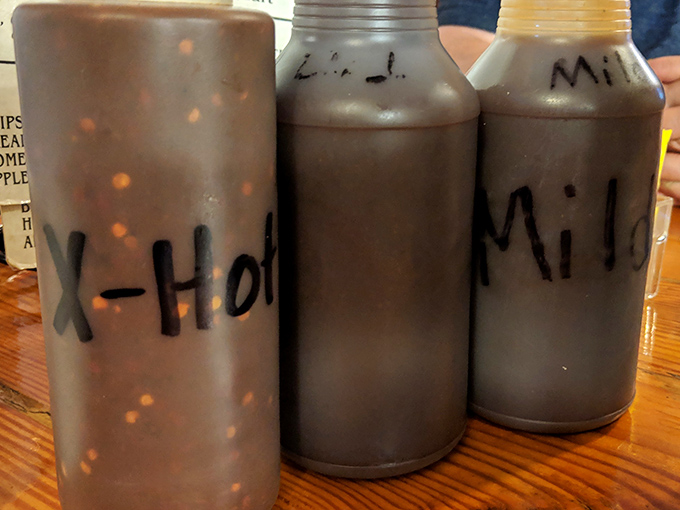 Sauce bottles labeled with delicious simplicity. In the barbecue world, these aren't condiments&mdash;they're liquid personality profiles for your meat.