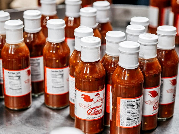 Bottles of liquid gold standing at attention. The G-Sauce squadron awaits deployment to elevate your chicken experience to legendary status.