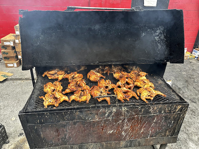 Chicken quarters doing the backstroke in smoke&mdash;achieving that perfect mahogany color that signals flavor has penetrated to the bone.