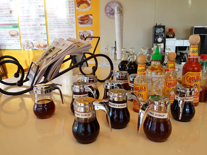 The syrup station—liquid gold in labeled dispensers, waiting to transform your waffle from merely delicious to transcendent. Choose your adventure wisely.