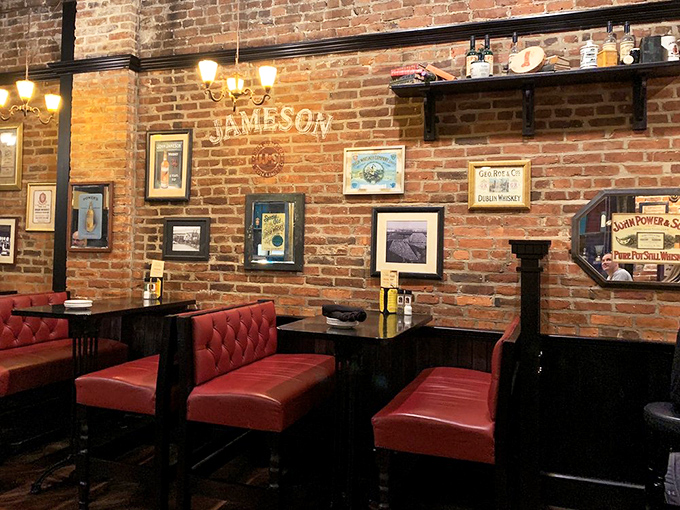 Red leather booths against exposed brick walls create those perfect corners where great conversations happen and food memories are made.