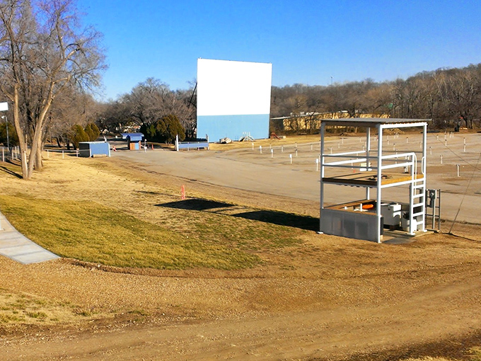 In winter's dormancy, the empty lot and towering screen stand in quiet anticipation of summer crowds and blockbuster nights to come.