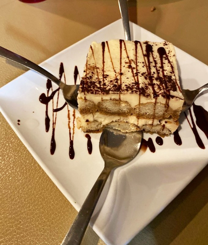 Tiramisu with chocolate drizzle—proof that coffee, cake, and cream can solve approximately 87% of life's problems when properly combined.
