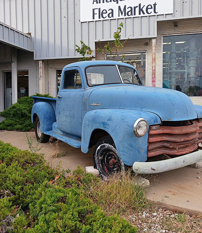 This weathered blue Chevy isn't just decoration—it's the unofficial mascot of Owls Nest, silently promising authentic vintage finds inside.