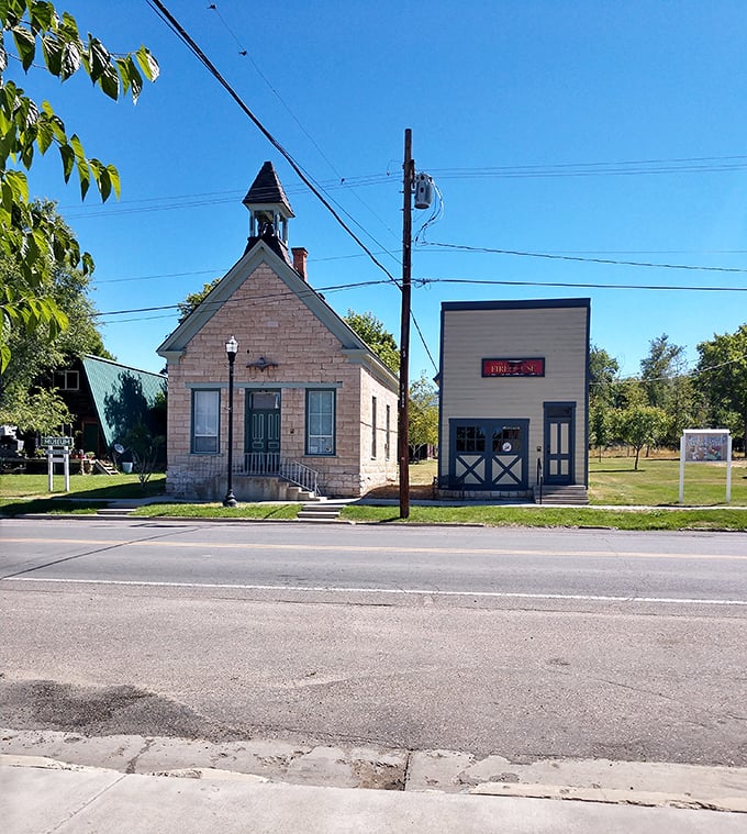 This limestone chapel and neighboring storefront remind us that in small towns, sacred spaces and everyday places have coexisted for generations.