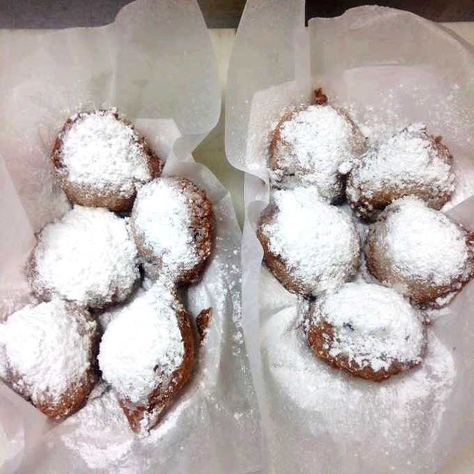 Powdered sugar snowcapped donut holes that disappear faster than you can say "just one more." Dessert perfection in bite-sized form.