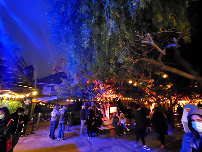 Visitors gather in the courtyard during a nighttime event, collectively wondering if getting lost inside is included in the price of admission.